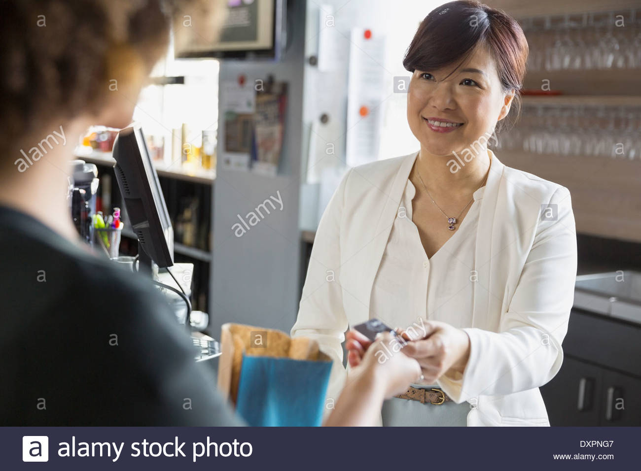 Woman counter cash receiving hi-res stock photography and images - Alamy