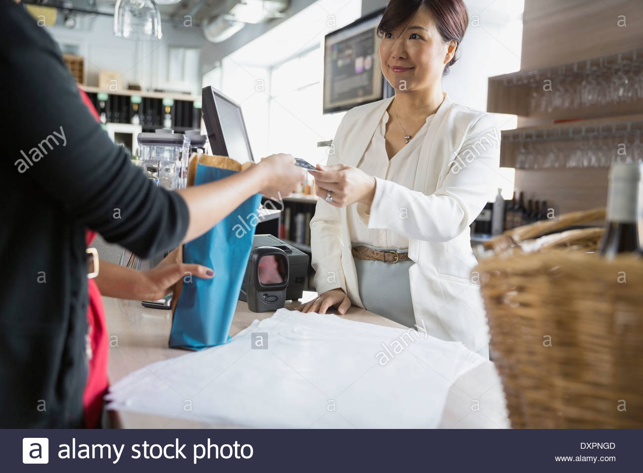 Young shopper giving money to cashier hi-res stock photography and ...