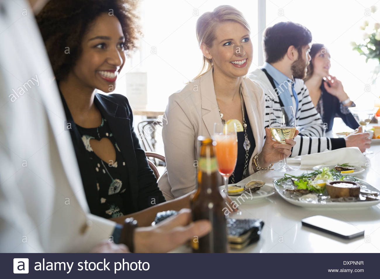 Young people drinking alcohol eating hi-res stock photography and ...