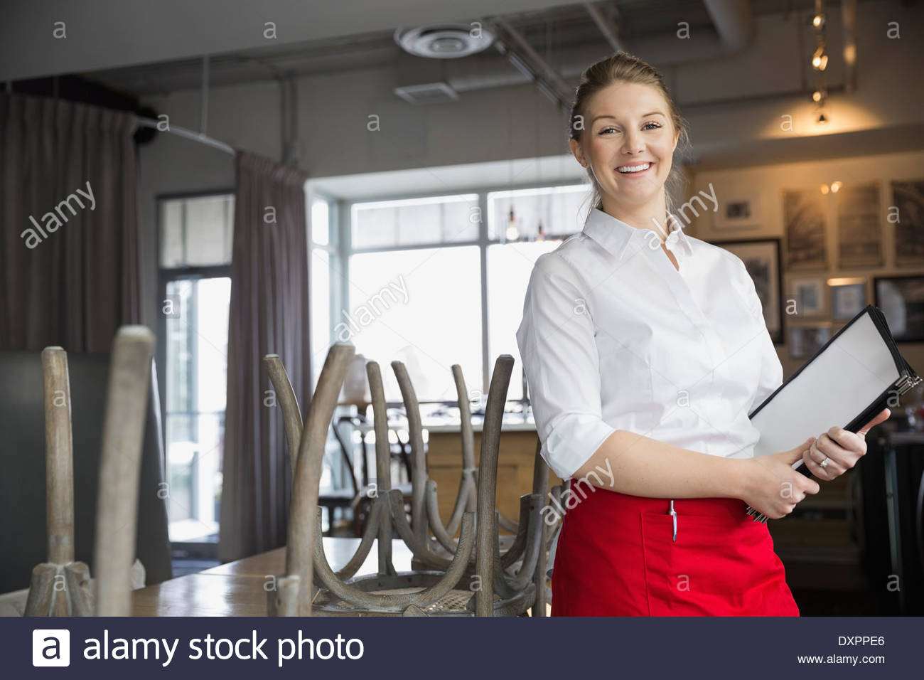 Young Waitress Greeting In Restaurant High Resolution Stock Photography ...