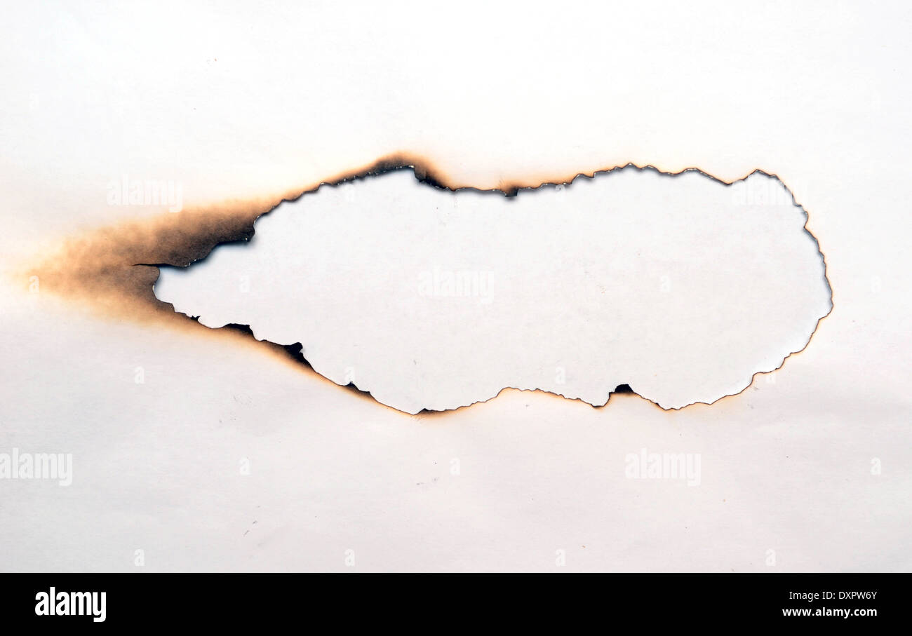 burnt hole in a paper Stock Photo - Alamy