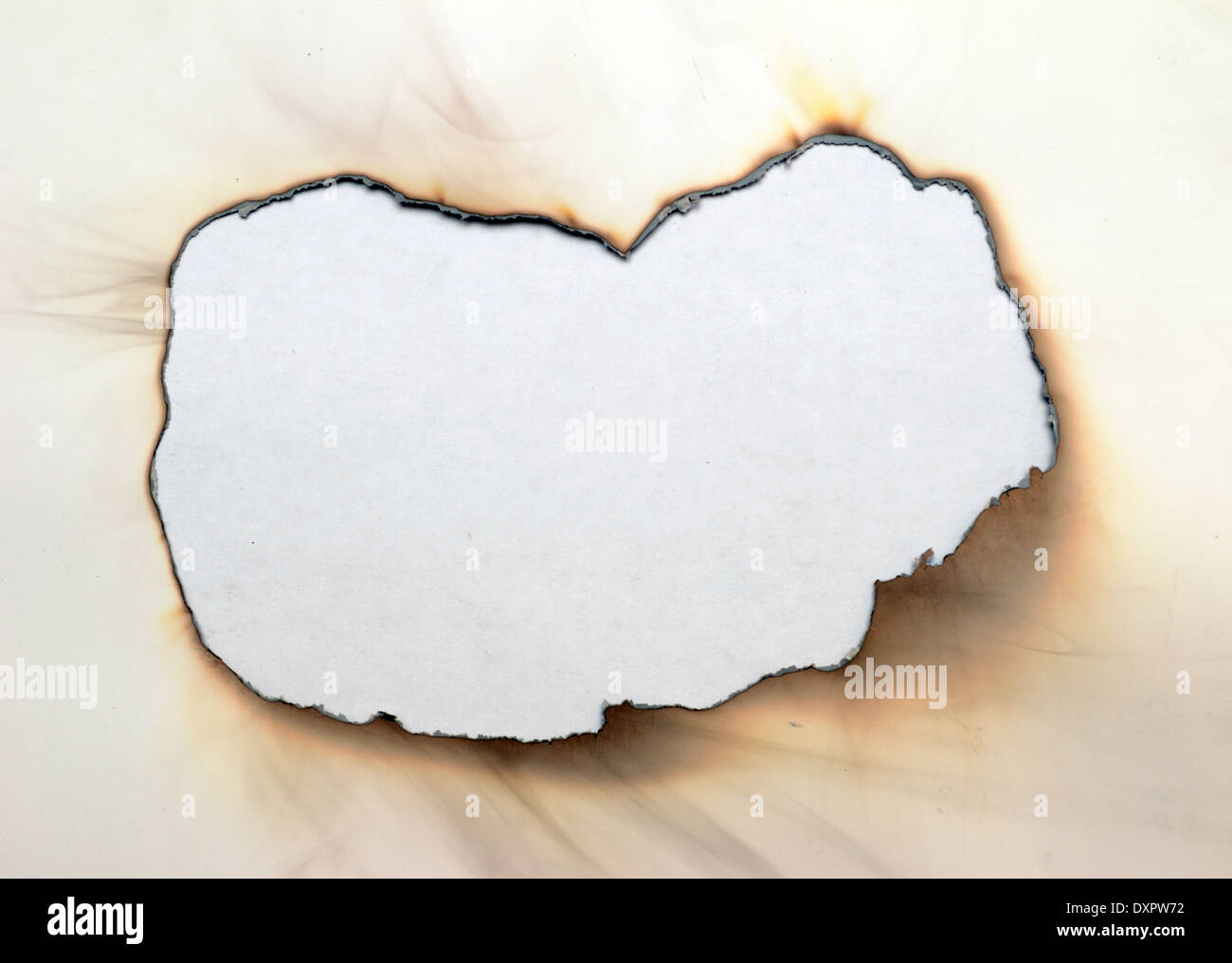 burnt hole in a paper Stock Photo - Alamy