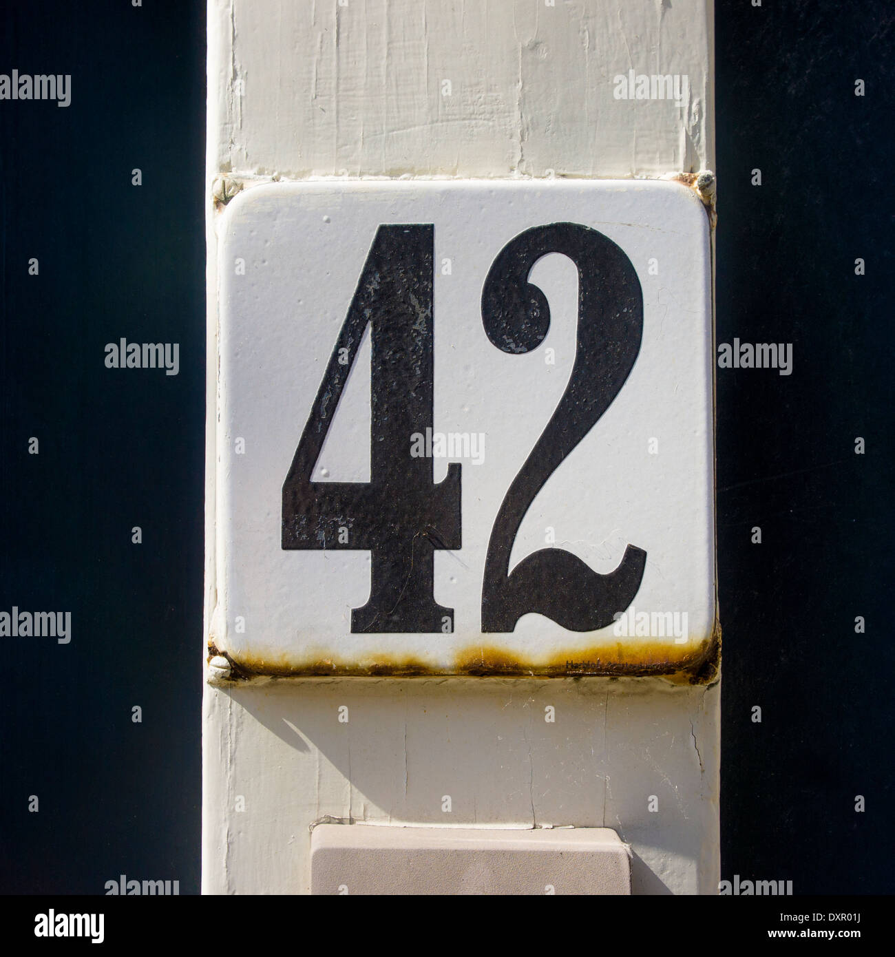 enameled house number forty two. Black lettering on a white background ...