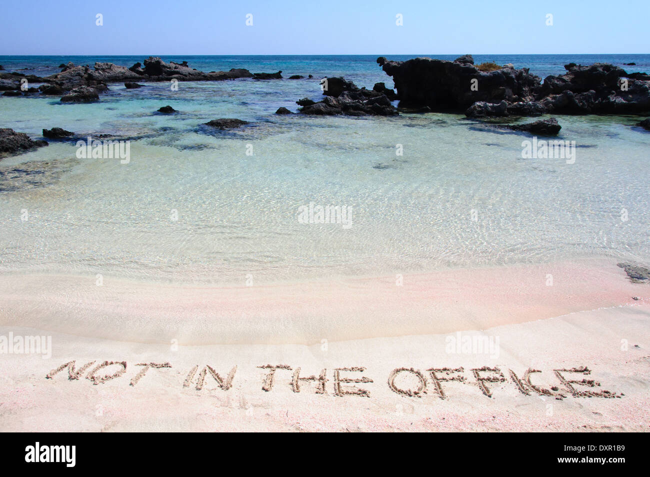 OUT OF OFFICE written on sand on a beautiful beach, blue waves in ...