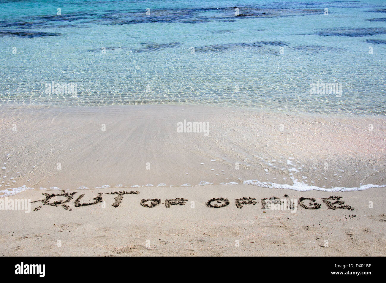 OUT OF OFFICE written on sand on a beautiful beach, blue waves in ...