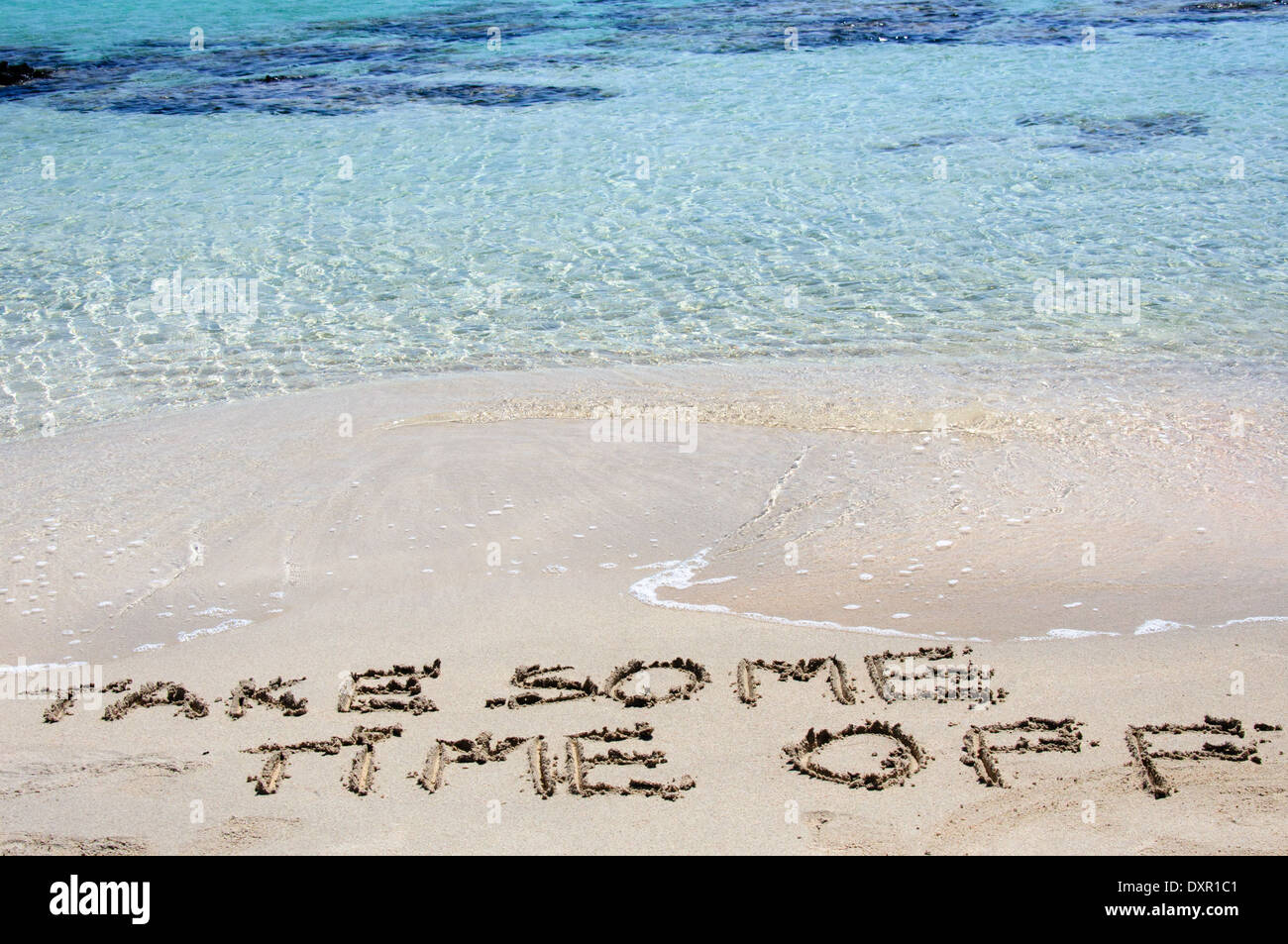 TAKE SOME TIME OFF written on sand on a beautiful beach, blue waves in ...