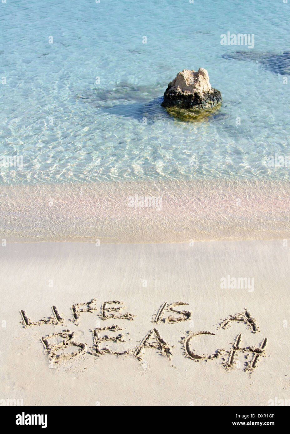 Life is a beach message written on white sand, with tropical sea waves ...