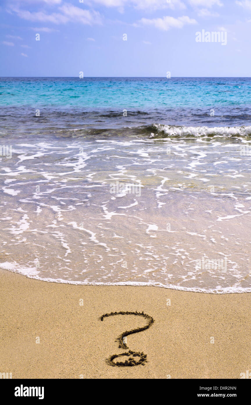 question mark sign in sand beach, sea water and clear blue sky Stock ...