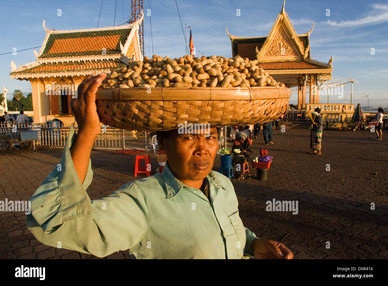 Peanuts seller near Tonle Sap River. Phnom Penh. A mixture of Cambodian ...