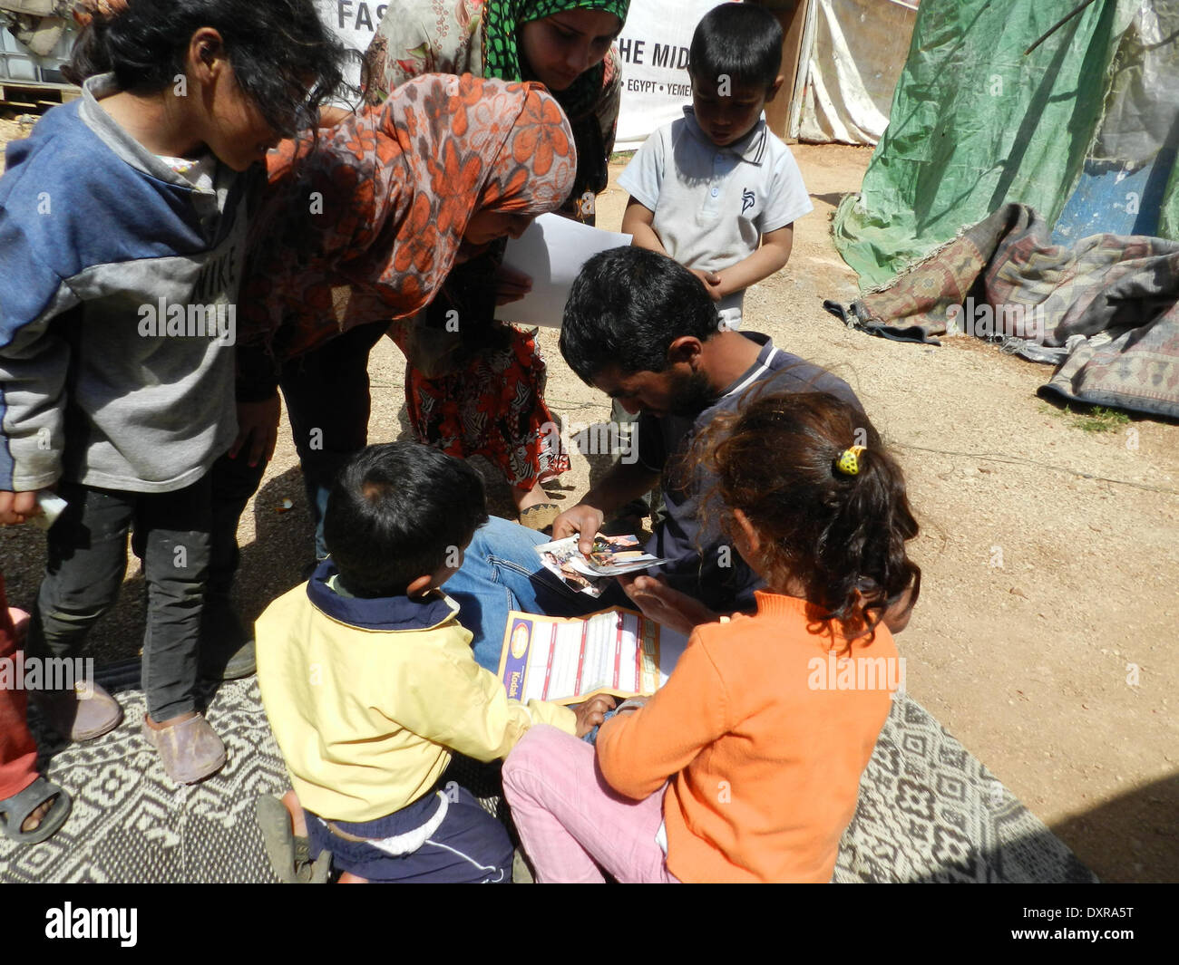 Beirut. 29th Mar, 2014. Syrians living in a refugee camp view family ...