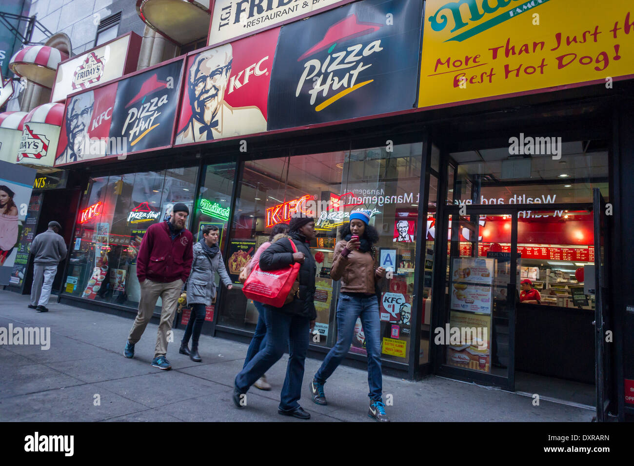 Signs for an assortment of fast food franchises located in one ...