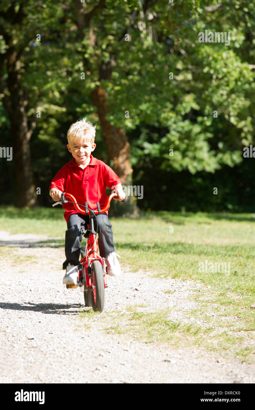 Young boy riding a bicycle Stock Photo - Alamy