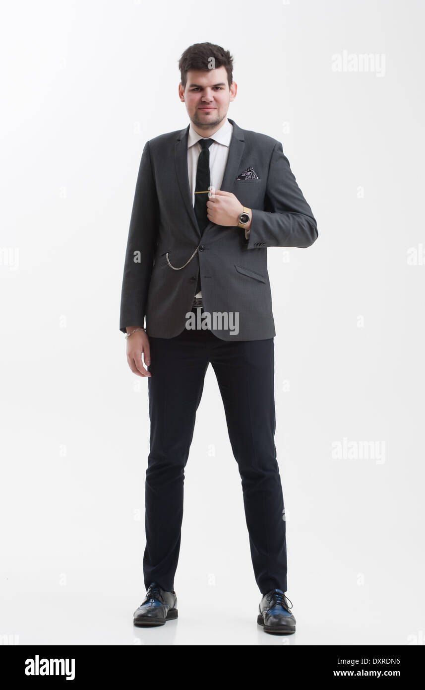 Handsome businessman stands at full height with crossed legs. Full body ...