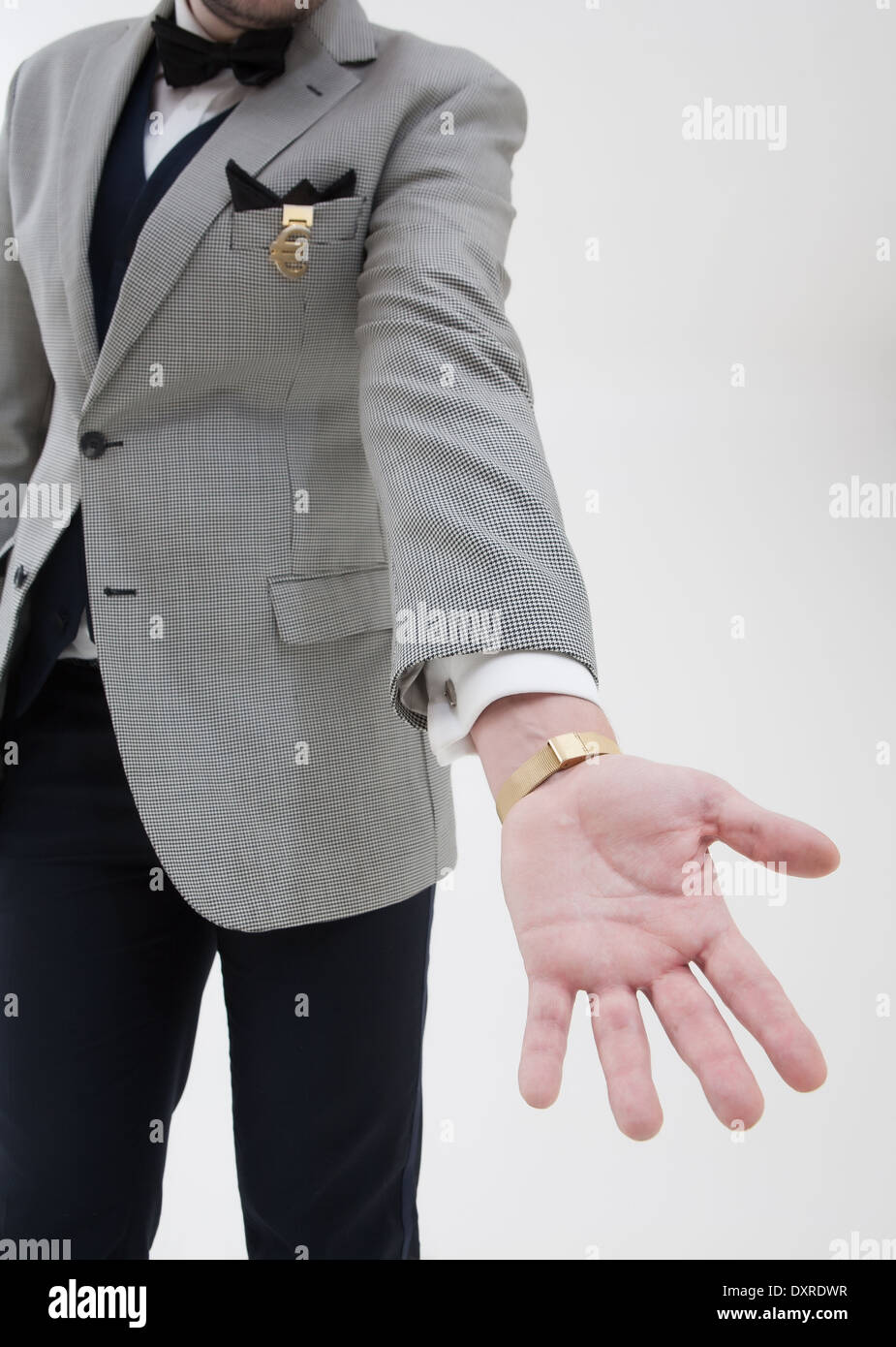 A man gives a helping hand. Hand with golden watch on wrist. Euro sign ...