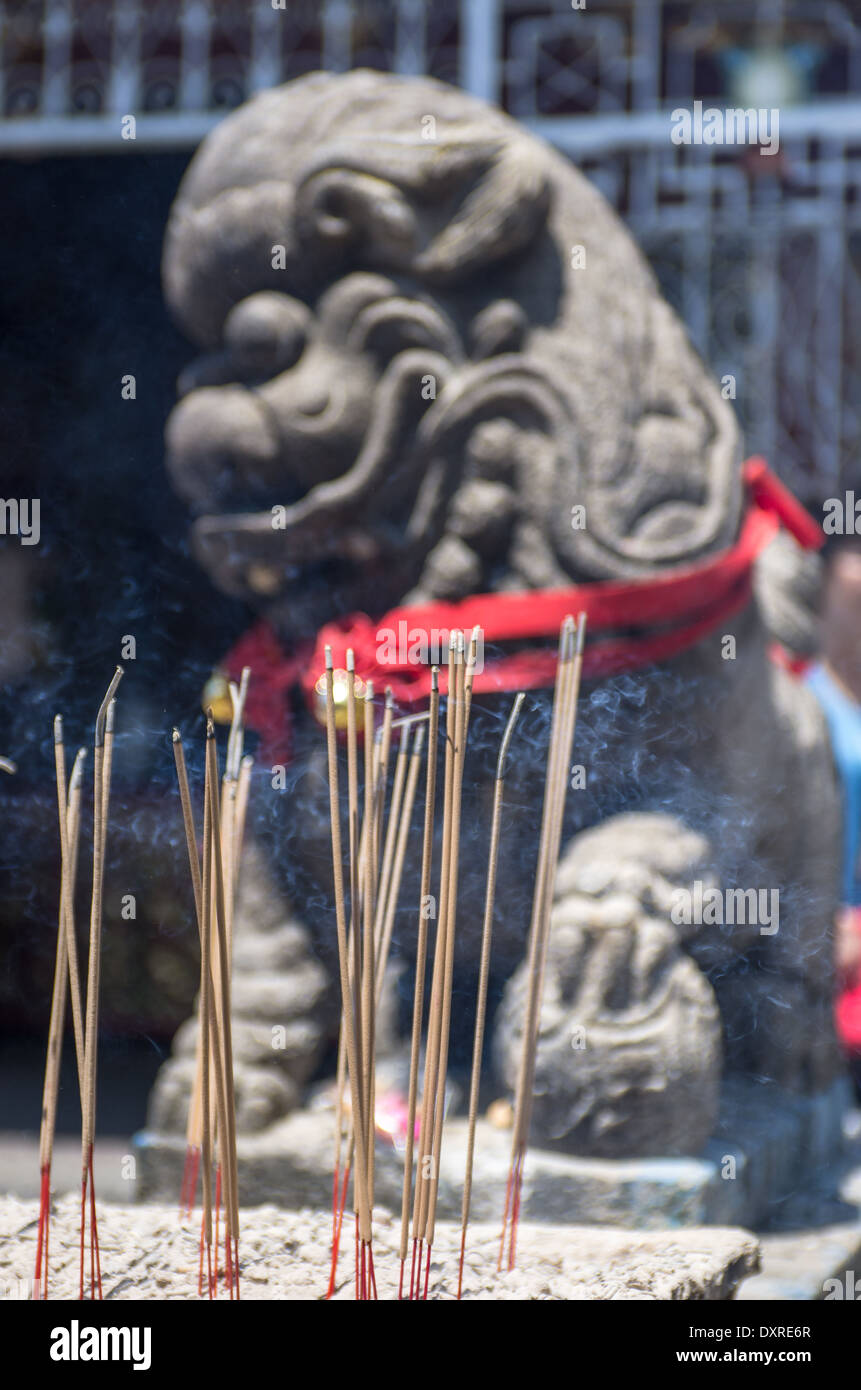 Holy incense sticks smoking outside Chinese temple Stock Photo - Alamy