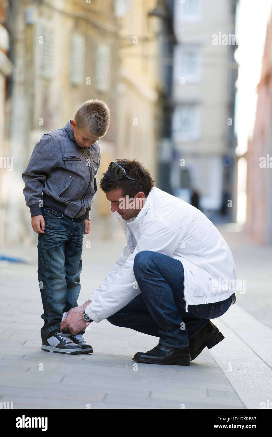 Father tying son's shoestring Stock Photo - Alamy