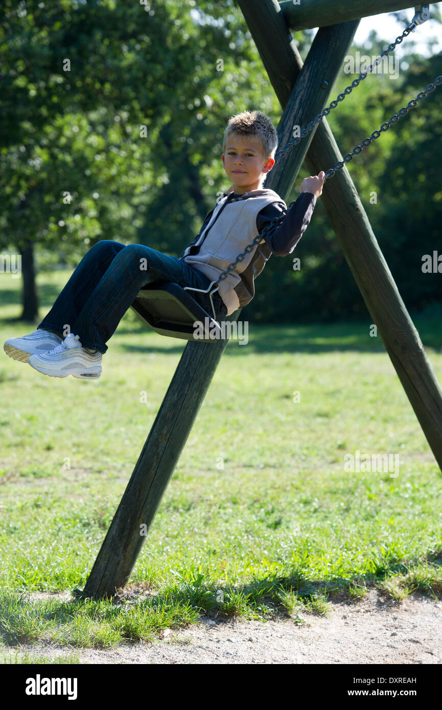 On a swing at the park hi-res stock photography and images - Alamy