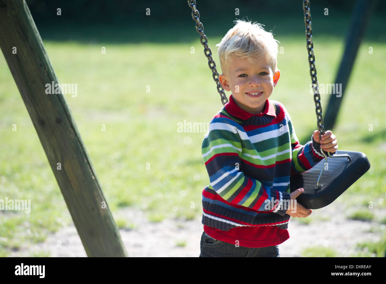 On a swing at the park hi-res stock photography and images - Alamy