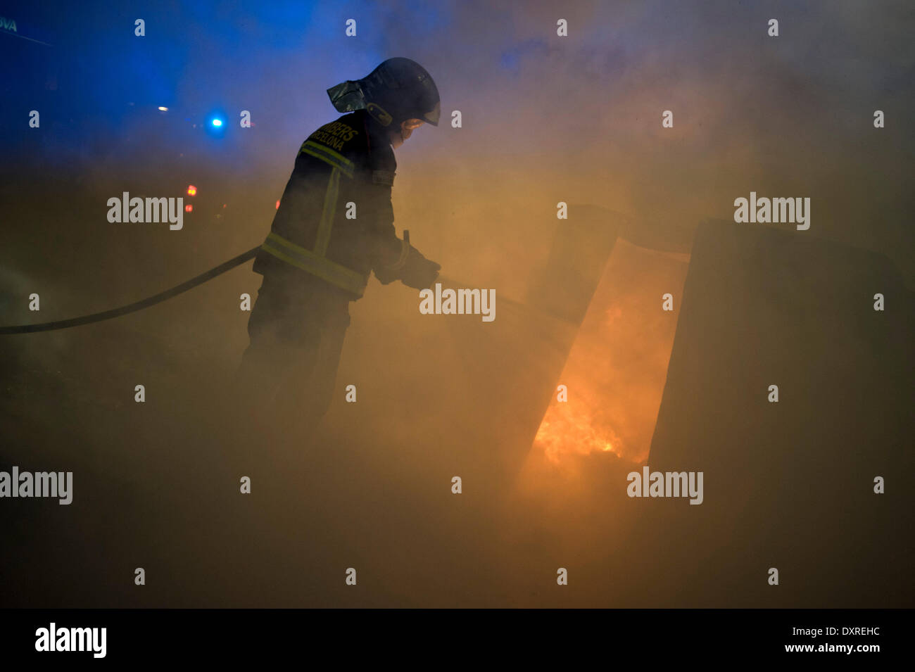 Barcelona, Spain -29th March, 2014.A firefighter extinguishes the fire ...