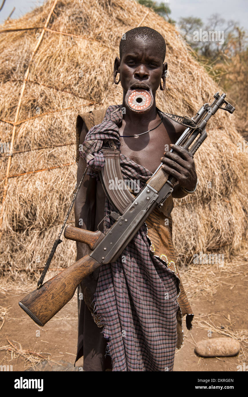 Mursi woman with lip plate and Kalashnikov in the Lower Omo Valley of ...