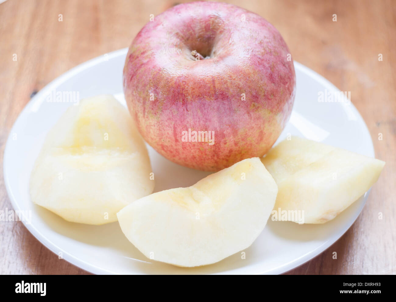 Red apple peeled on the dish, stock photo Stock Photo - Alamy