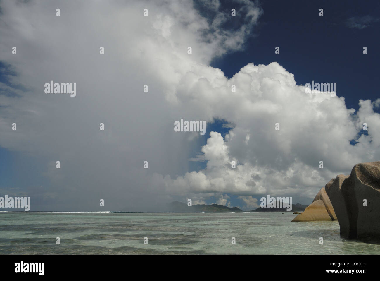 Rain Falling on Lagoon with Praslin in Background at Anse Source d ...