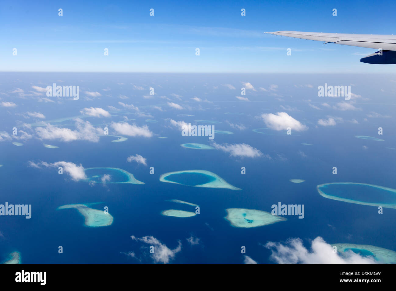 View from the window of an airplane flying above the Maldive Islands in ...