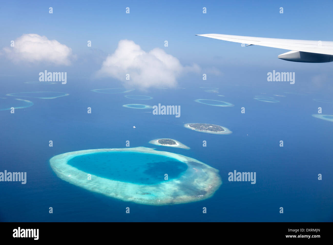 View from the window of an airplane flying above the Maldive Islands in ...