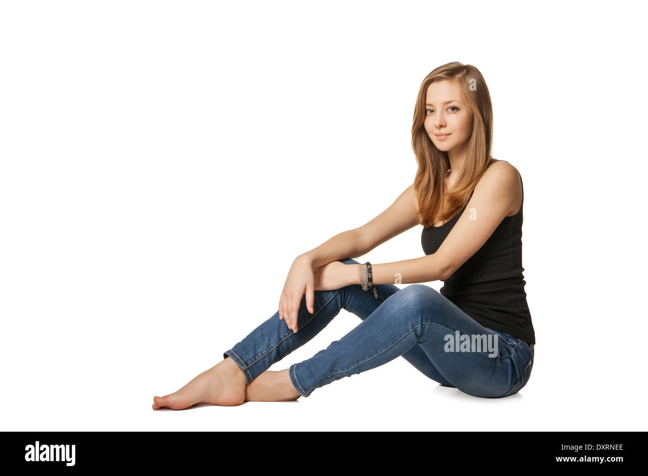 Attractive caucasian girl sitting on floor over white background Stock ...