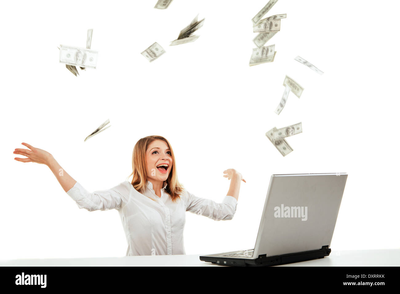 Young woman with laptop and flying money. Isolated over white ...