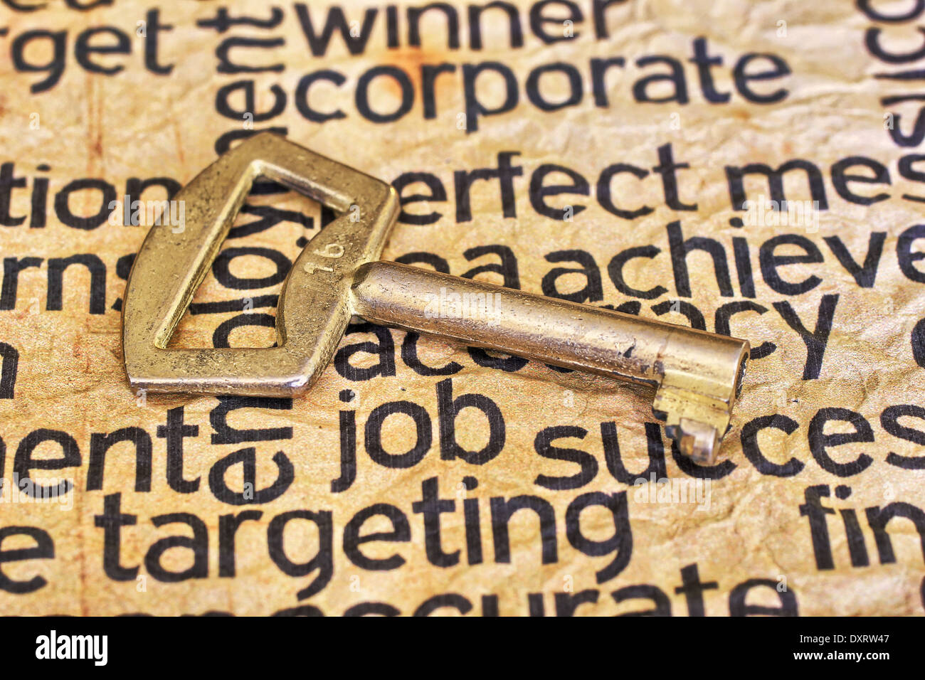 Golden key on job text Stock Photo - Alamy
