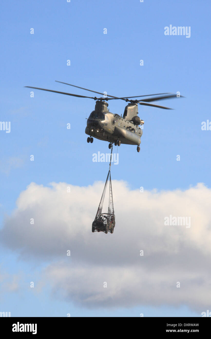 RAF Chinook helicopter carrying an Army Land Rover as an under slung ...