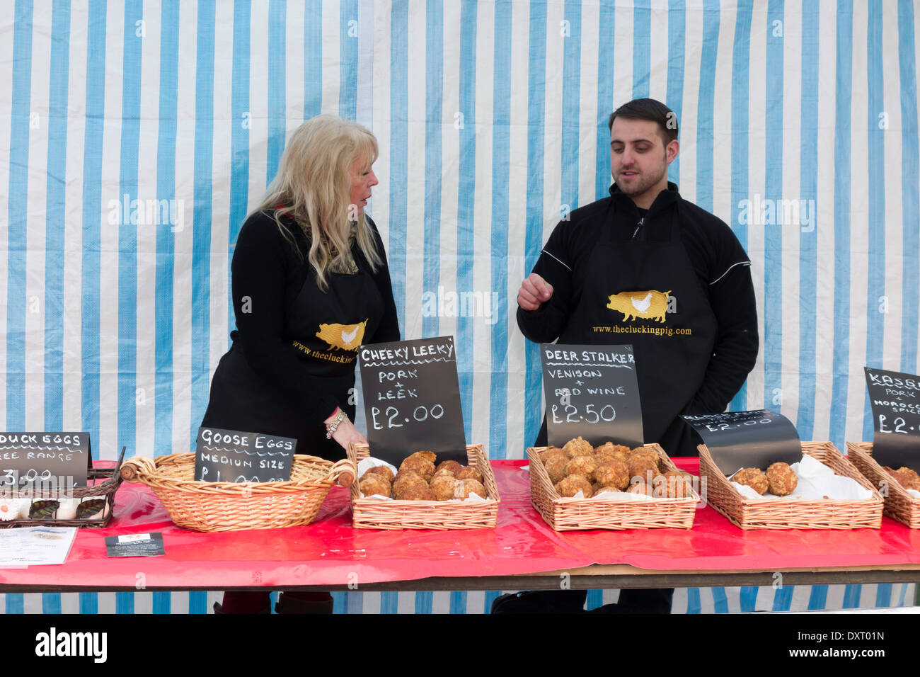 Street market stallholders man and woman selling Gourmet Scotch Eggs ...