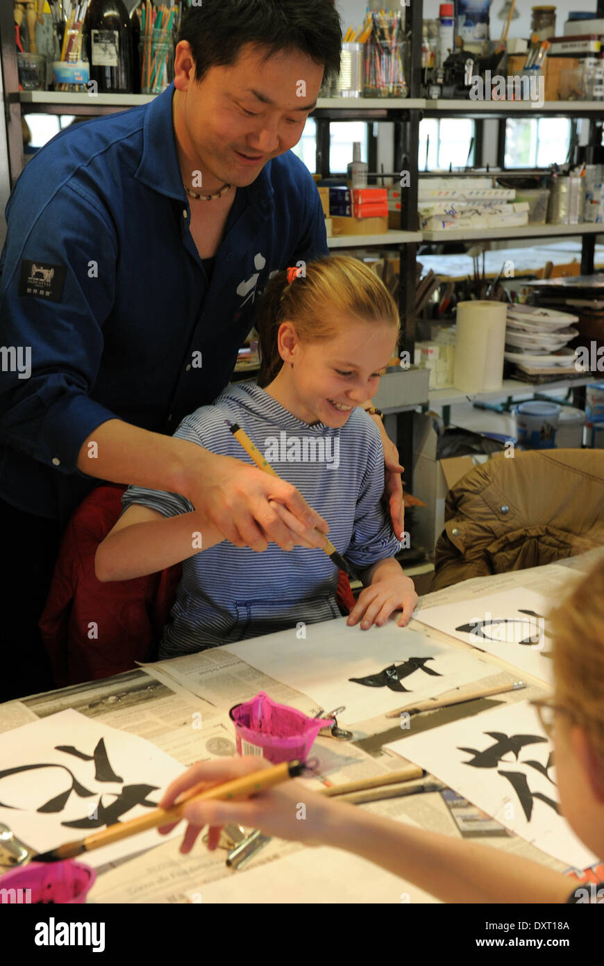Japanese artist and calligraphy master HARU (L) instructs school ...