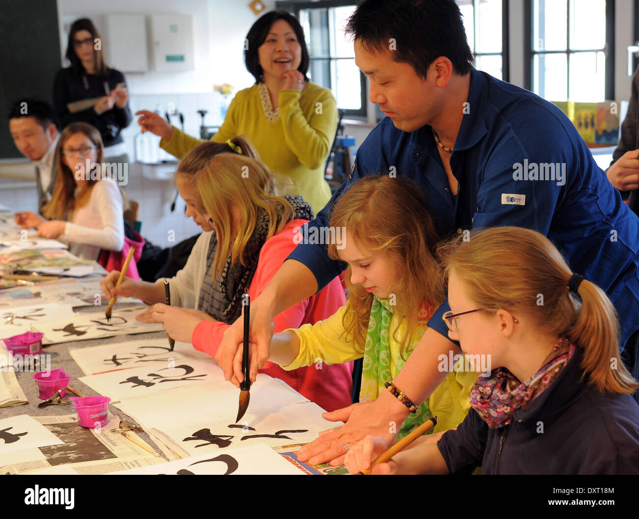 Japanese artist and calligraphy master HARU (R, back) instructs 6th ...
