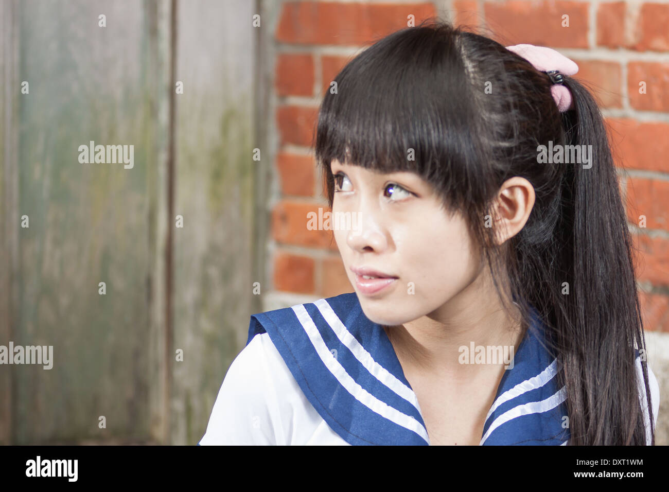 Chinese student standing outside red brick school building Stock Photo ...