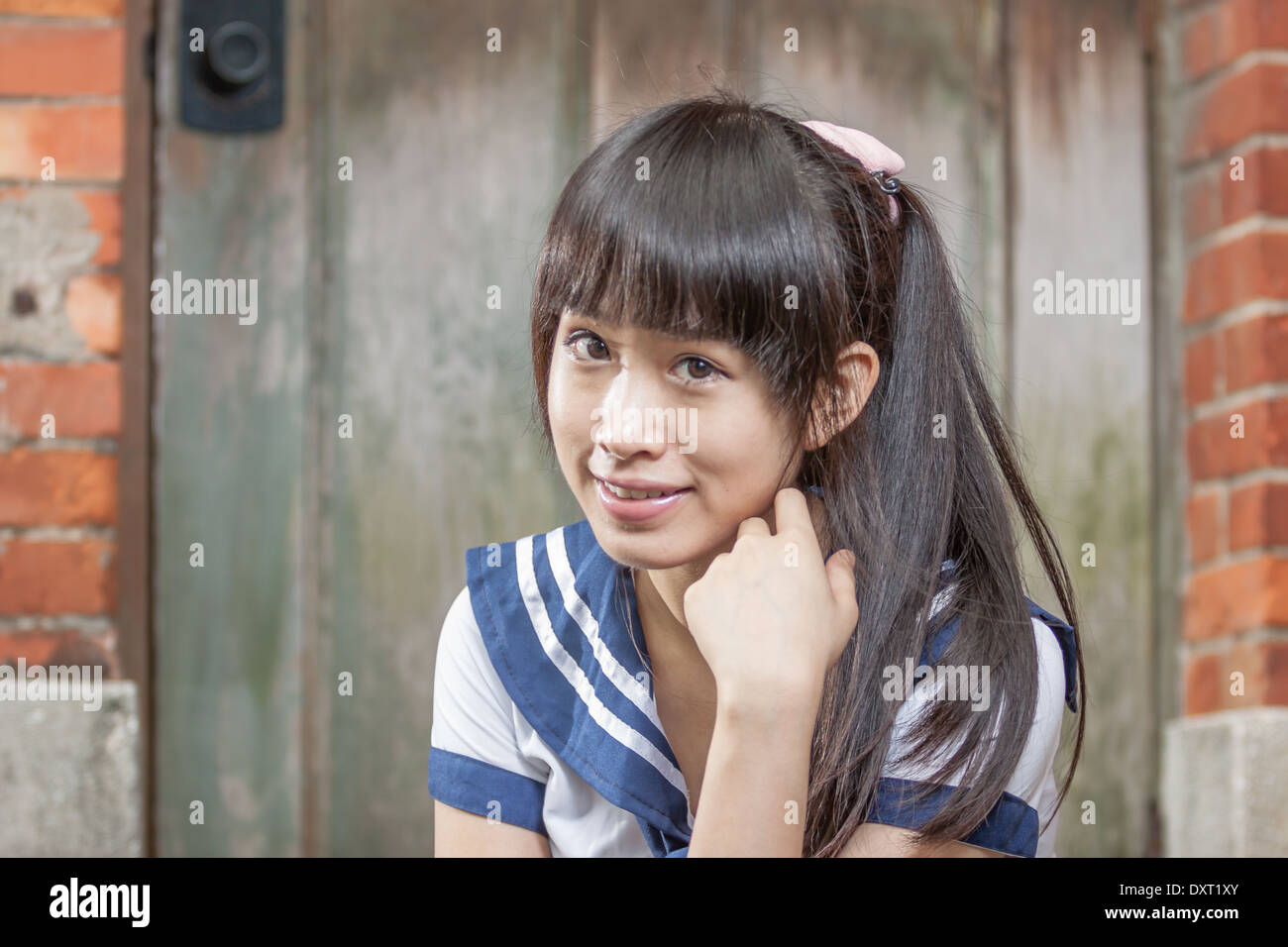 Chinese student standing outside red brick school building Stock Photo ...