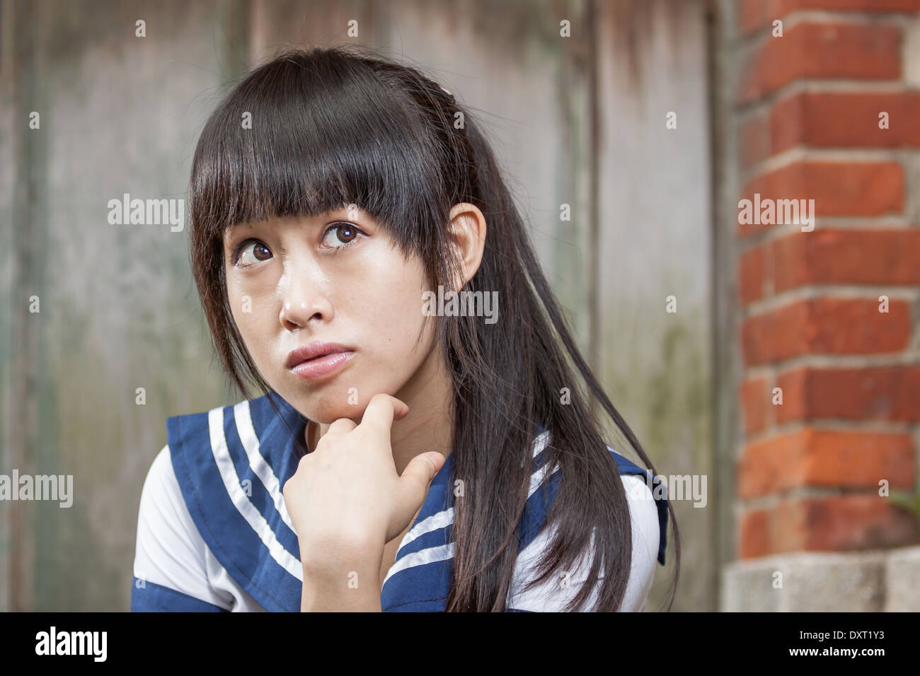 Chinese student standing outside red brick school building Stock Photo ...