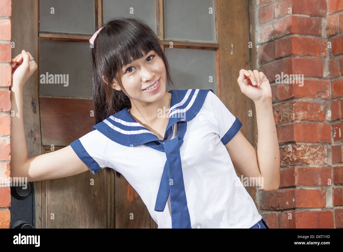 Chinese student standing outside red brick school building Stock Photo ...