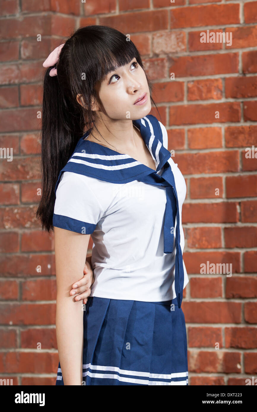 Chinese student standing outside red brick school building Stock Photo ...