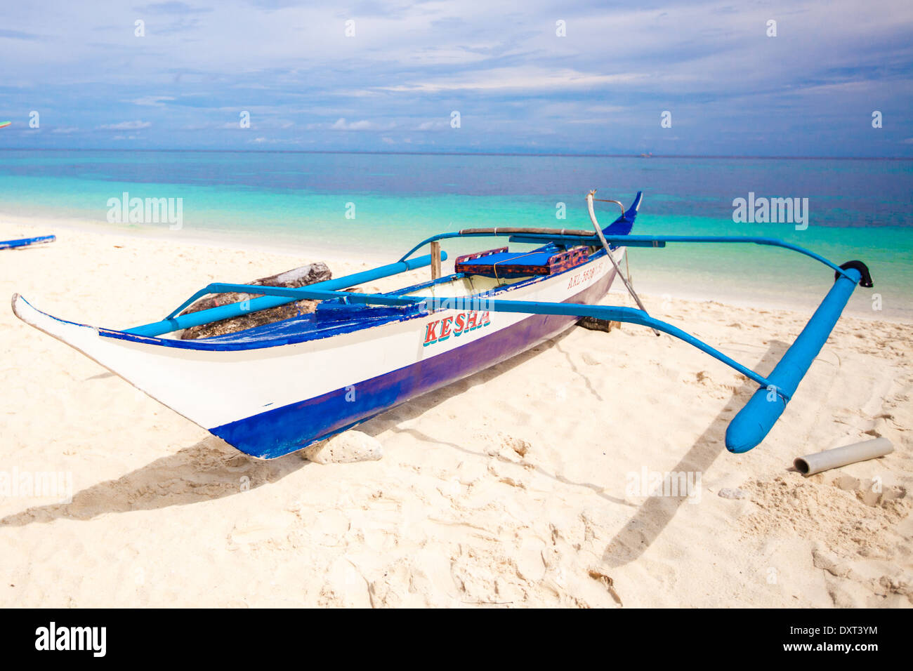 Small boat on the white beach in tropical island background blue skya ...