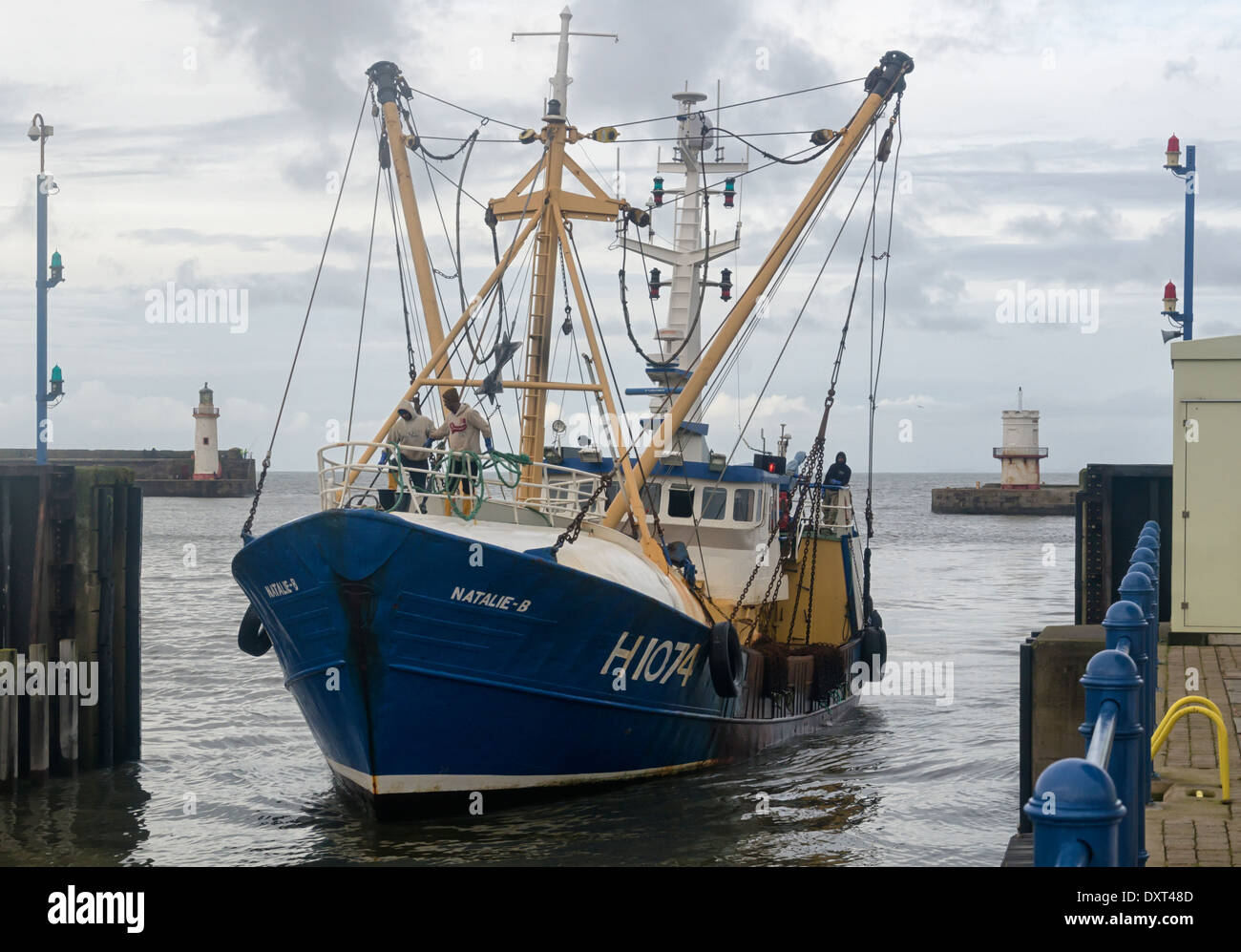 A blue trawler entering Whitehaven harbour Locks, returning from a ...