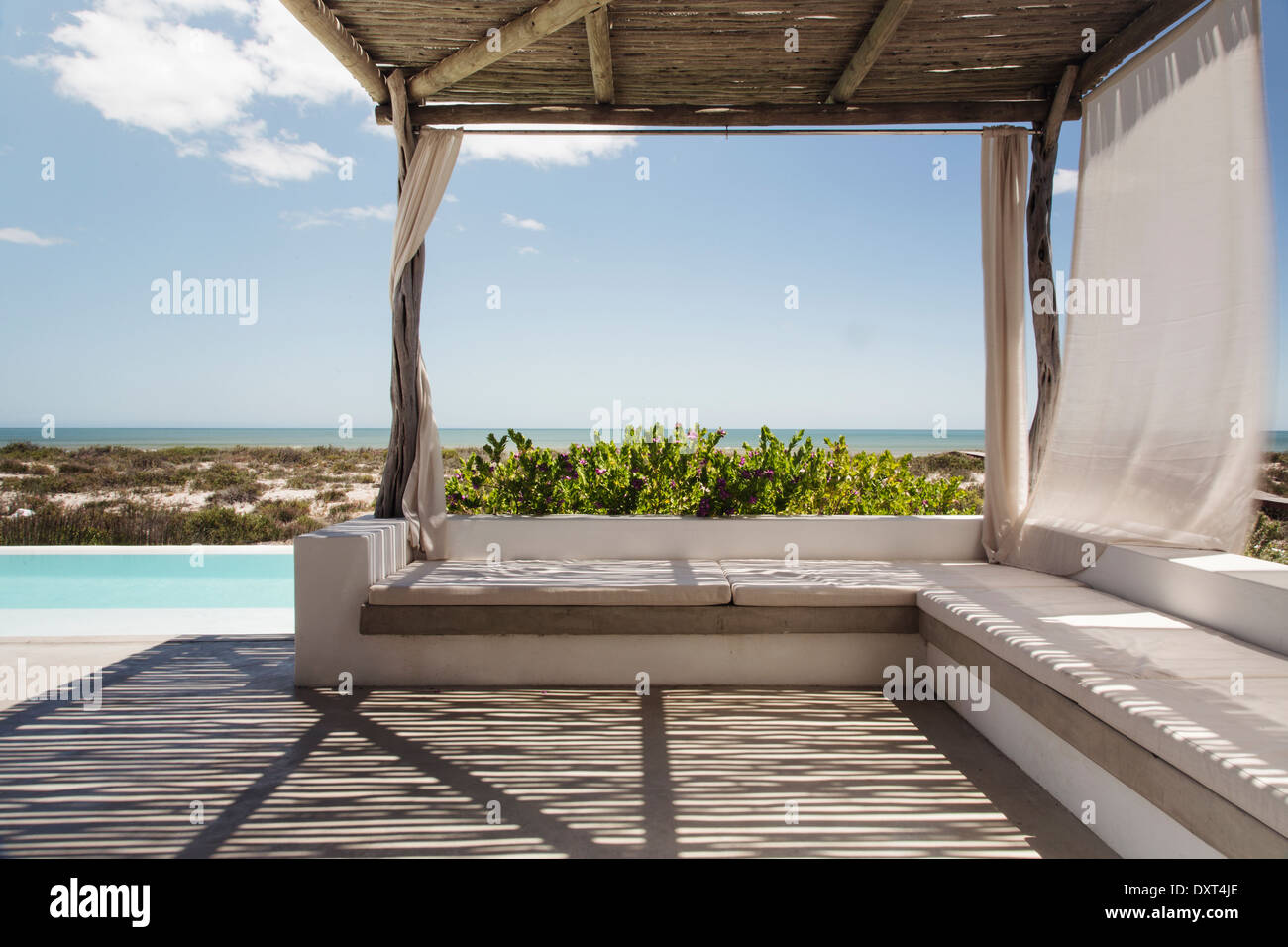 Luxury poolside patio overlooking ocean Stock Photo - Alamy