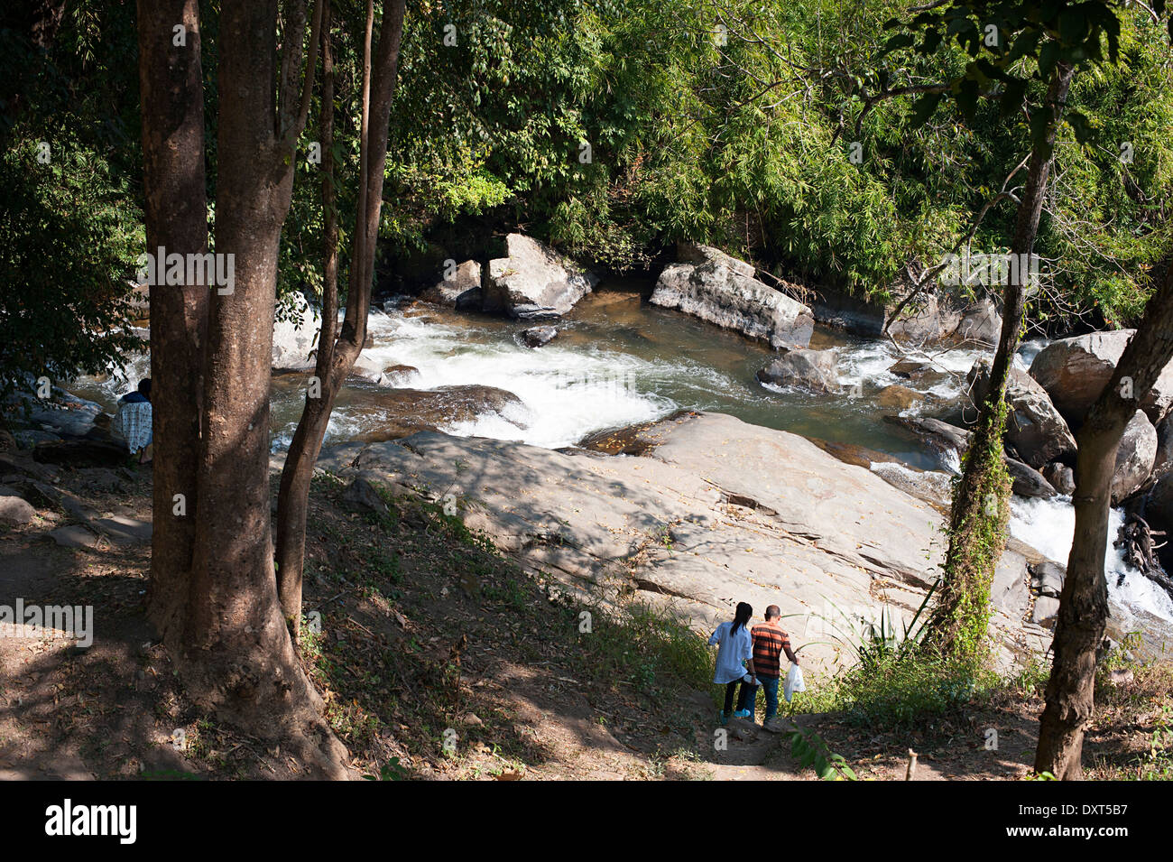 Visitors walk down to the river which flows from the Wachirathan ...