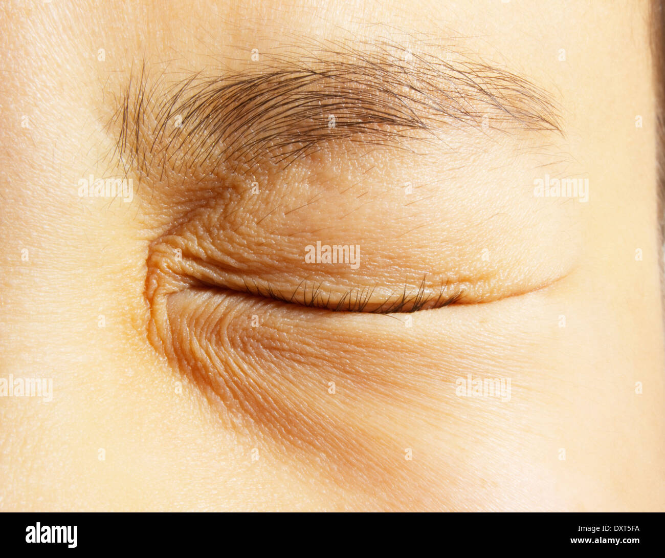 Extreme close up of girl squinting eye closed Stock Photo - Alamy
