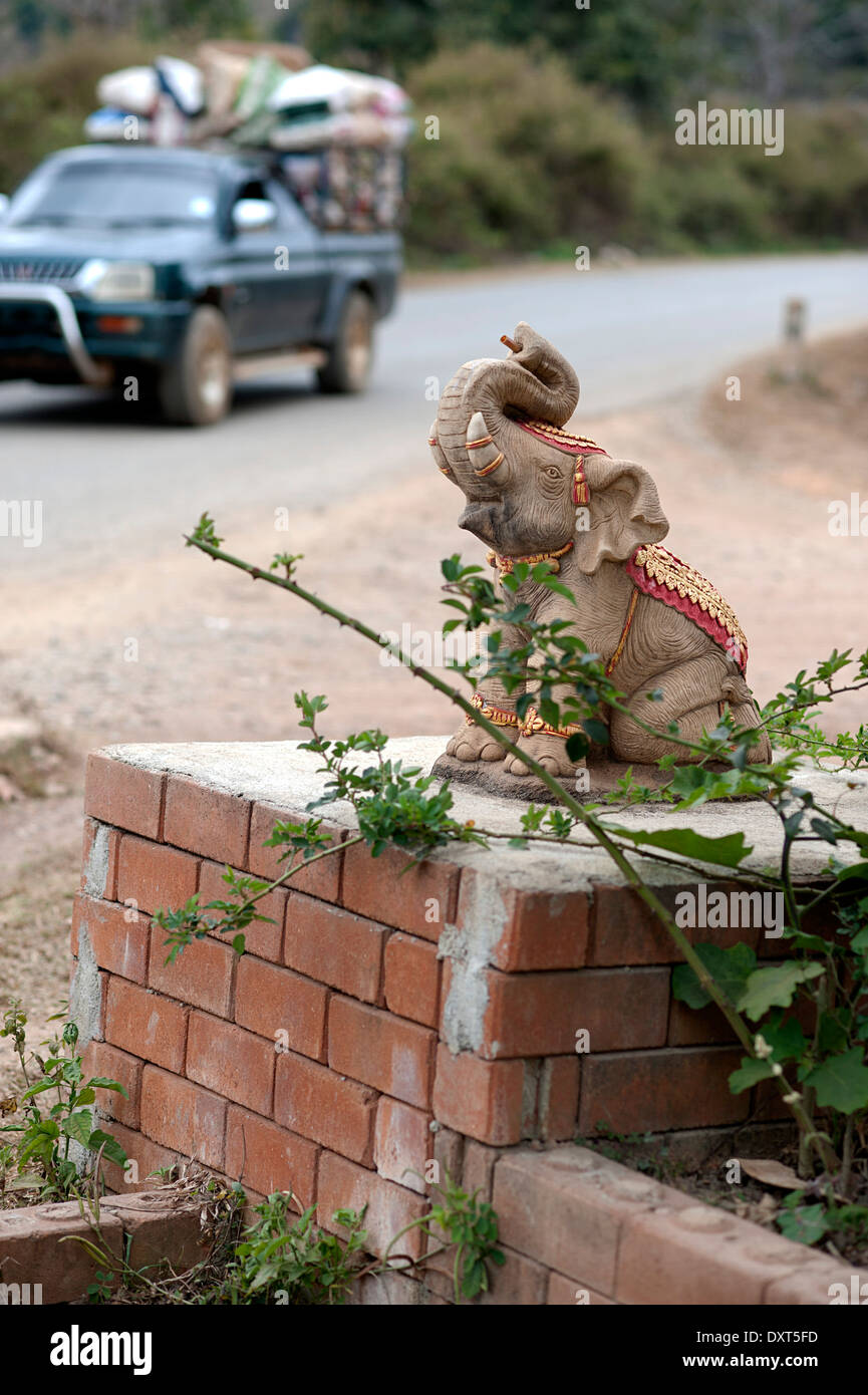 Stone carving of an elephant on a pillar at school entrance in Huay ...