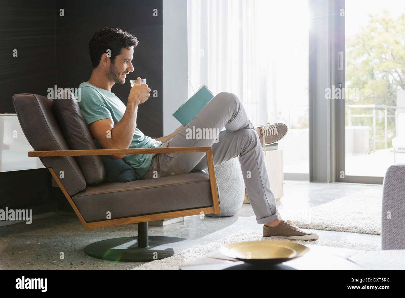 Seated man reading window hi-res stock photography and images - Alamy
