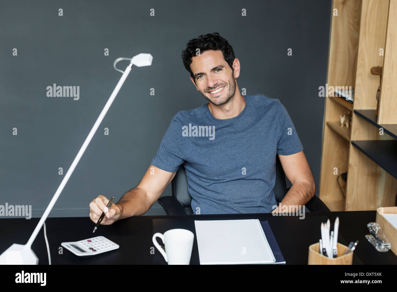 Portrait smiling person sitting desk hi-res stock photography and ...