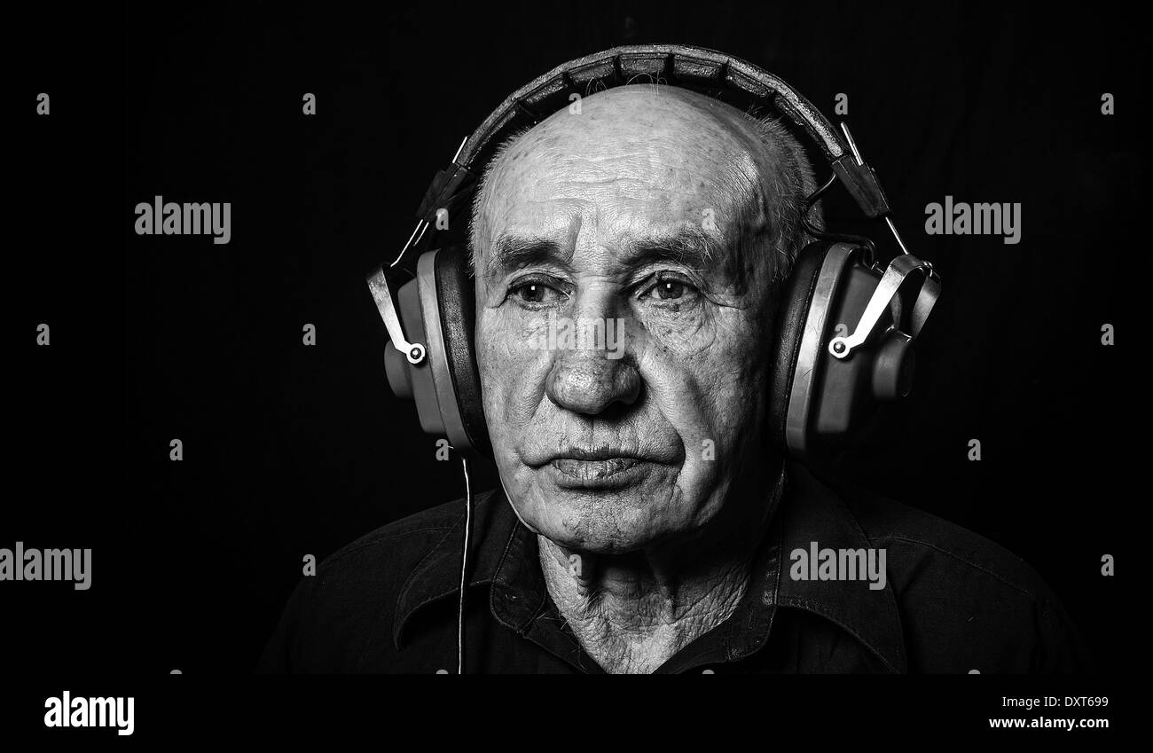 Studio portrait of an old man in headphones Stock Photo - Alamy