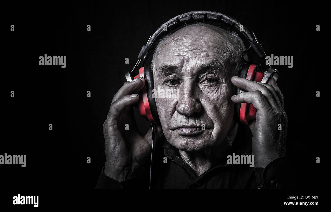 Studio portrait of an old man in headphones Stock Photo - Alamy